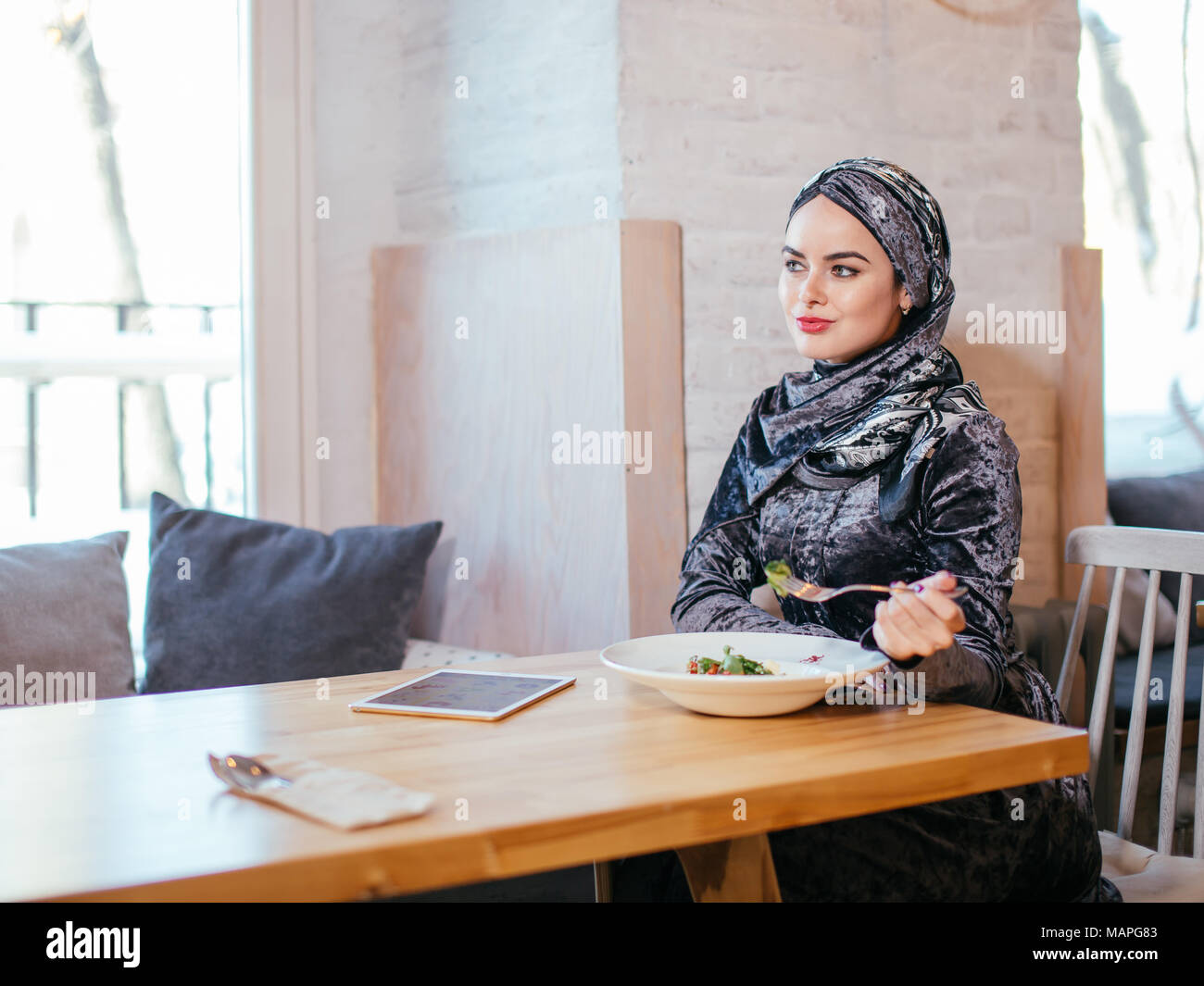 muslim woman eating at cafe with food Stock Photo - Alamy