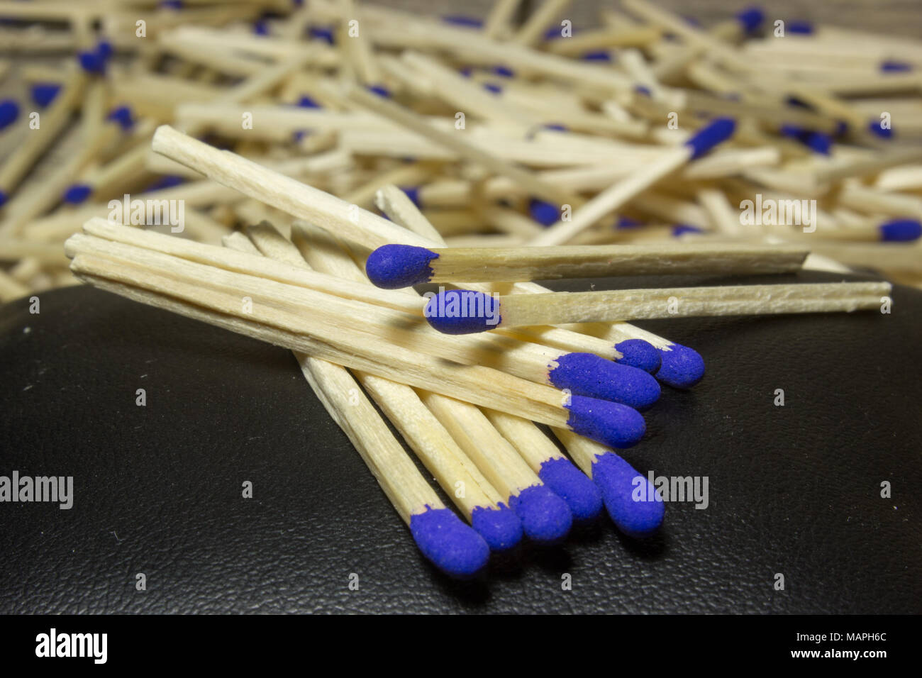 Matches with blue heads on black background Stock Photo - Alamy