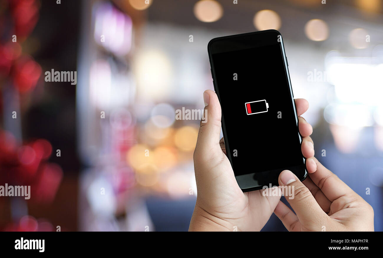 Close up man hands using smart phone battery low charged battery screen ...