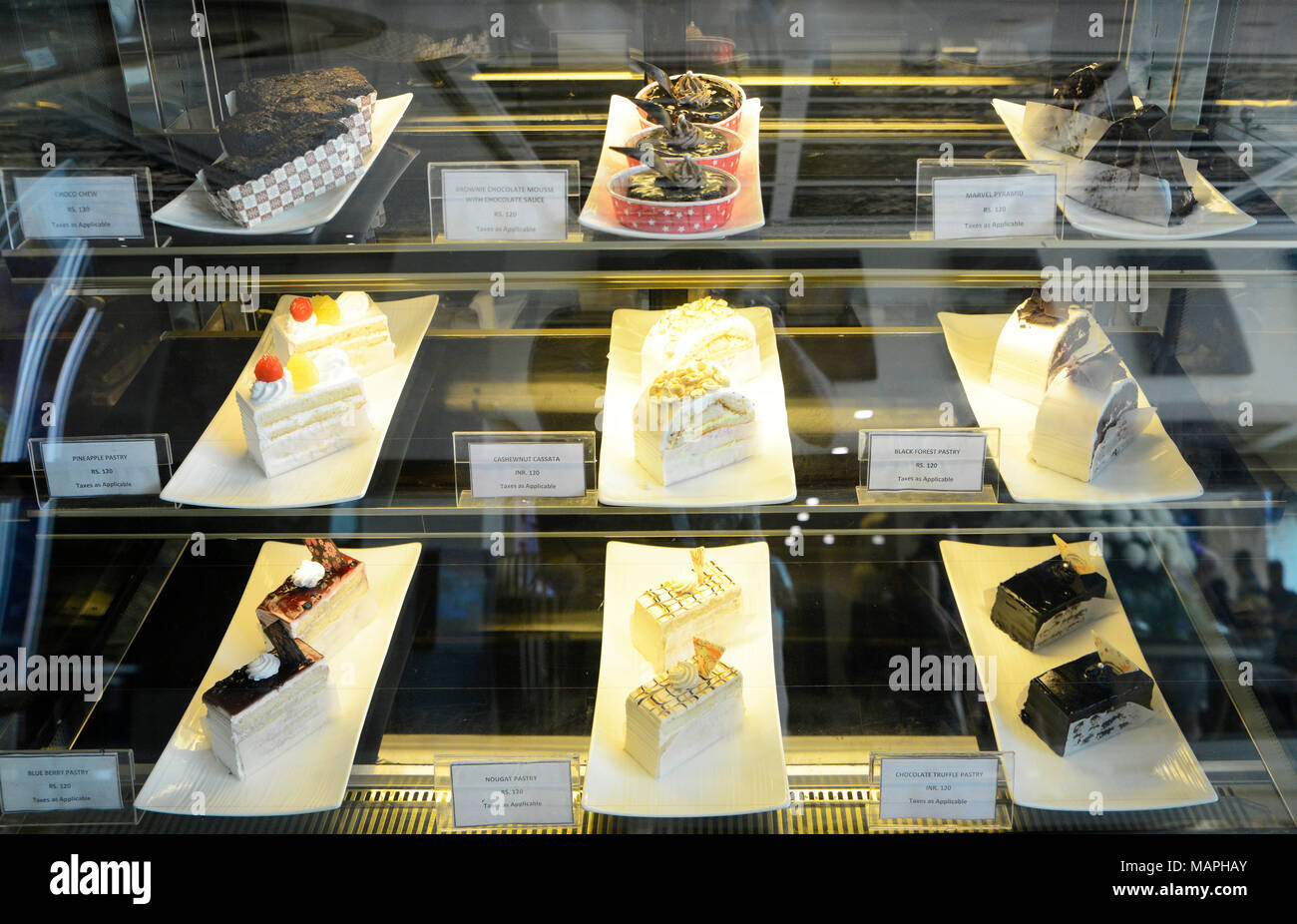 Various type of cakes in shop window in India Stock Photo - Alamy