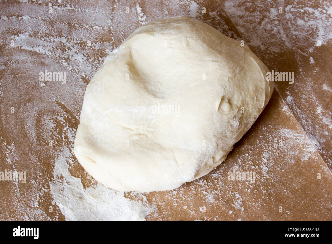 Dough on table with flour Stock Photo - Alamy