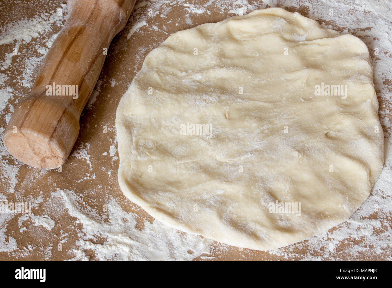 Dough on table with flour Stock Photo - Alamy