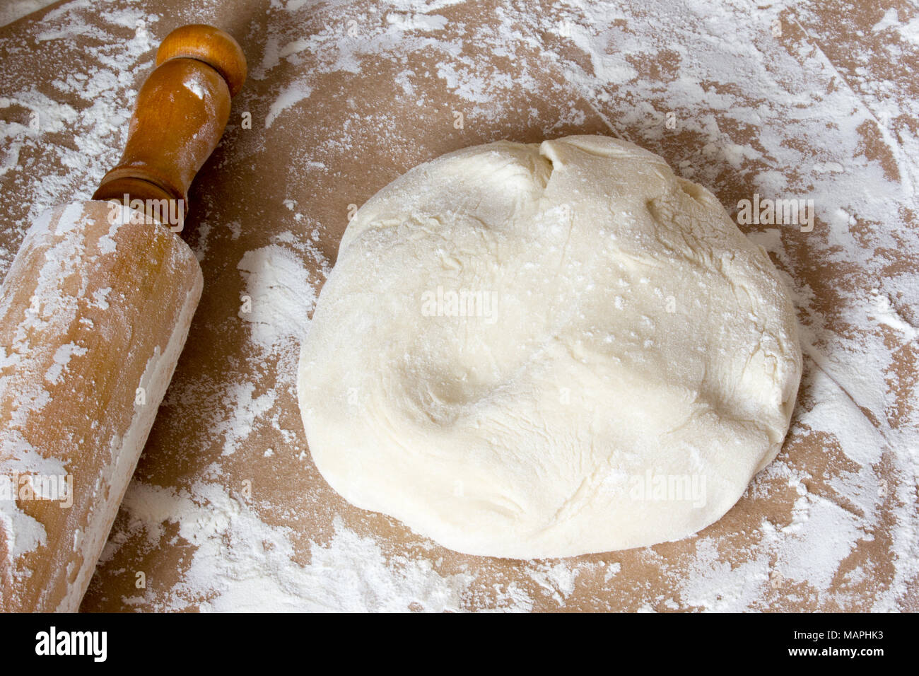 Dough on table with flour Stock Photo - Alamy