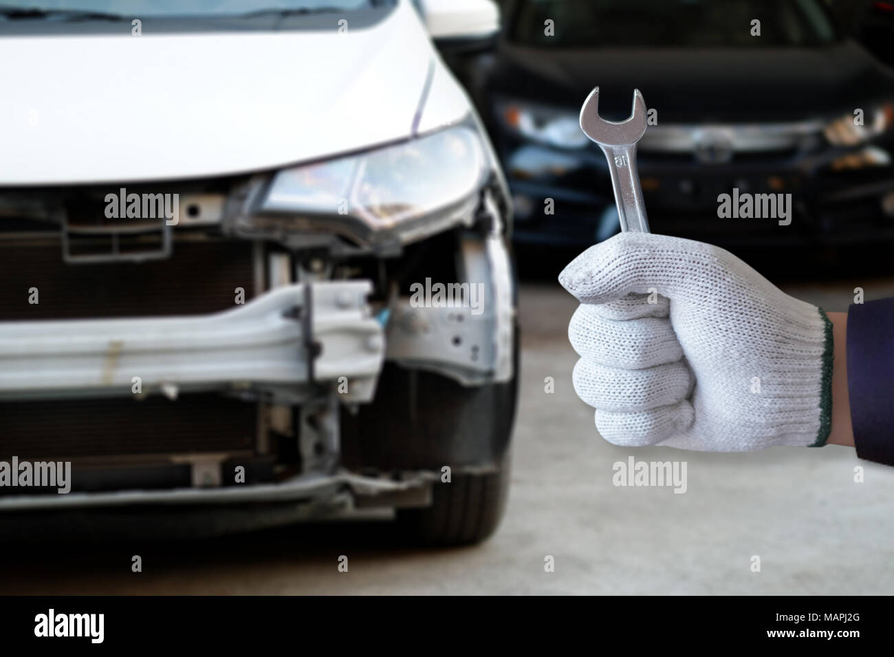 Mechanic repairing a car in garage Auto repair car engine Stock Photo ...