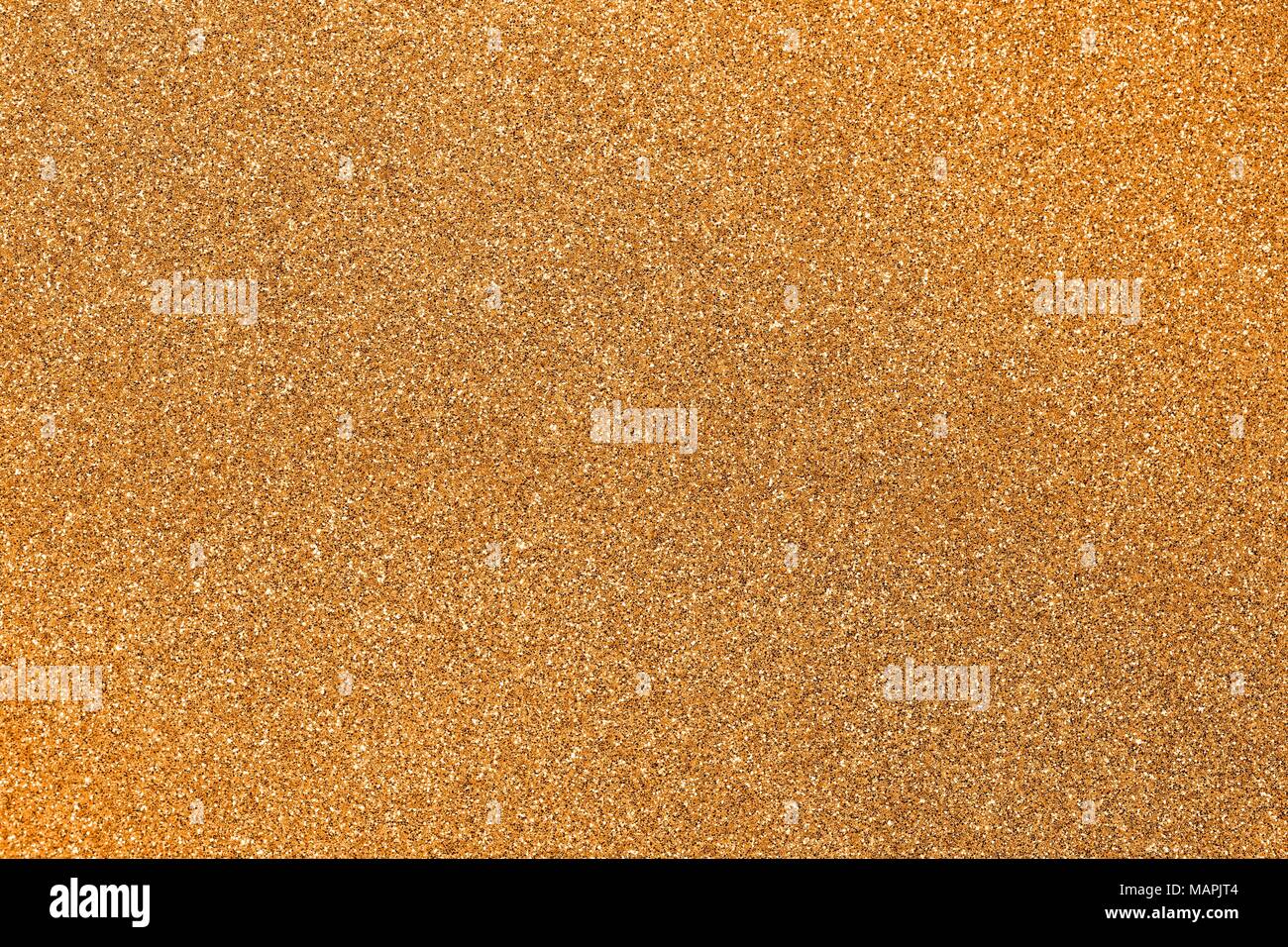 shimmering golden background in glittery material ideal as a very ...