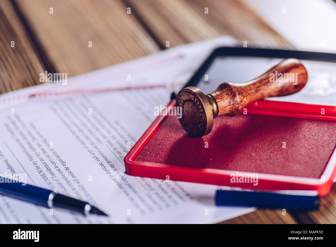 Red ink stamp on the document. Law concept Stock Photo - Alamy