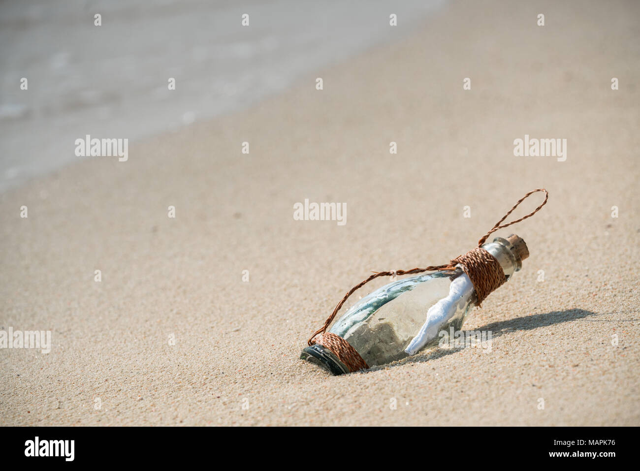 Letter message in a glass transparent bottle on the beach , concept for ...