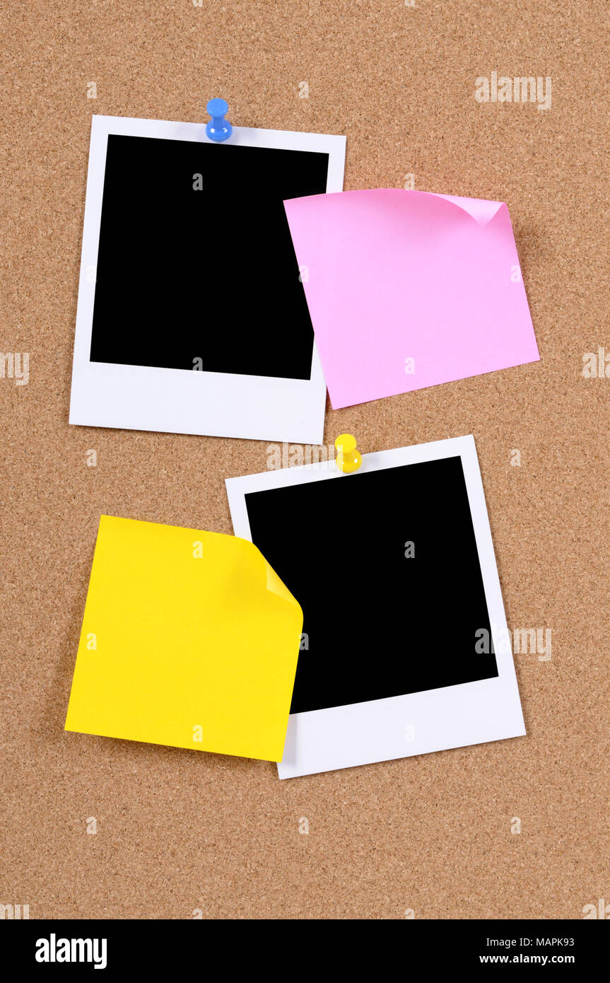 Blank photo prints with sticky notes pinned to a cork bulletin board ...