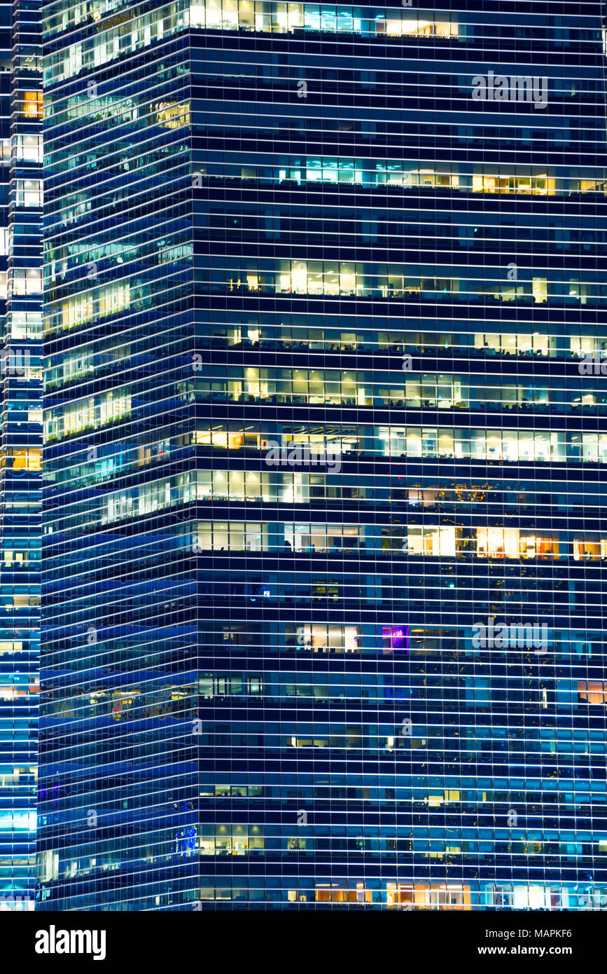 Glass facade of modern city high rise, buildings show lighting using by ...