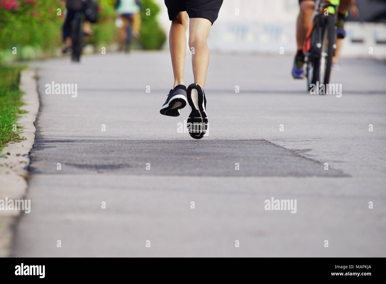 young fitness woman running for exercise at public park Stock Photo - Alamy