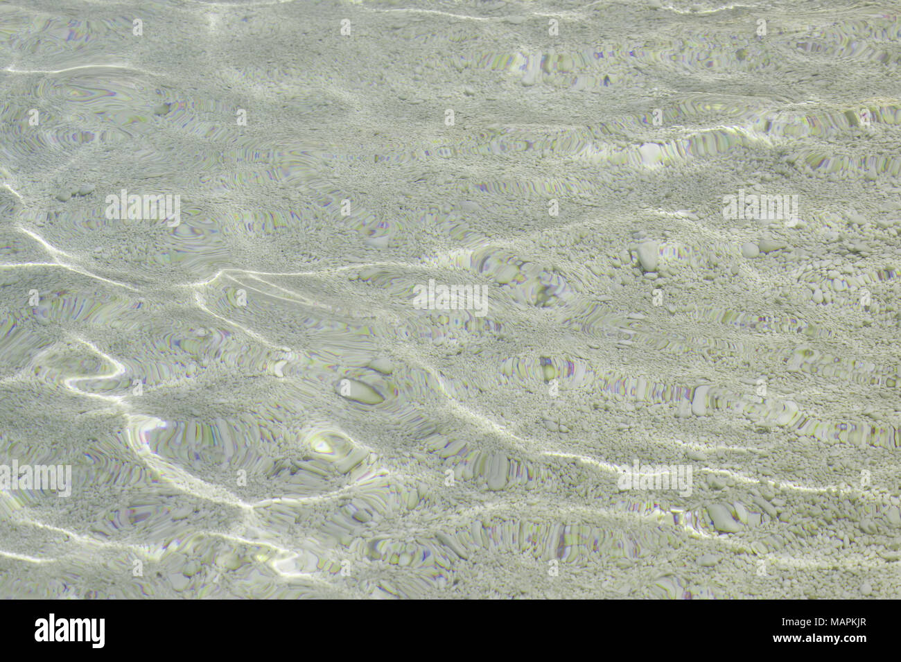 Lagoon water texture with small stones Stock Photo - Alamy