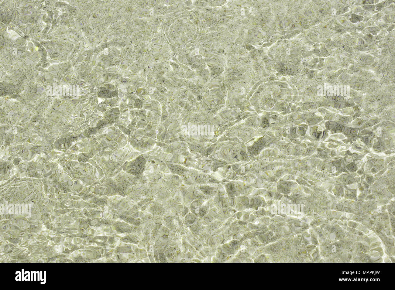 Lagoon water texture with small stones Stock Photo - Alamy