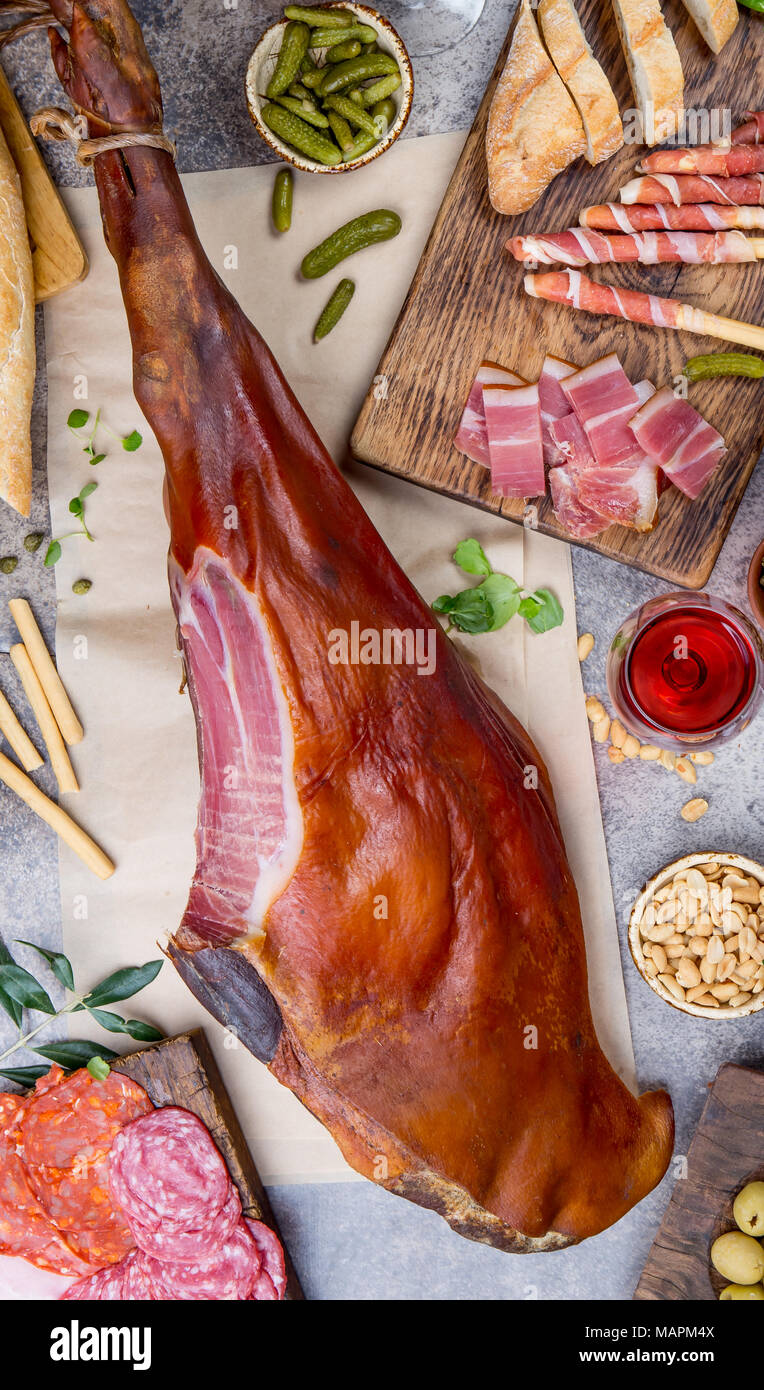 Appetizers table with spanish iberian whole ham jamon serrano, snacks ...