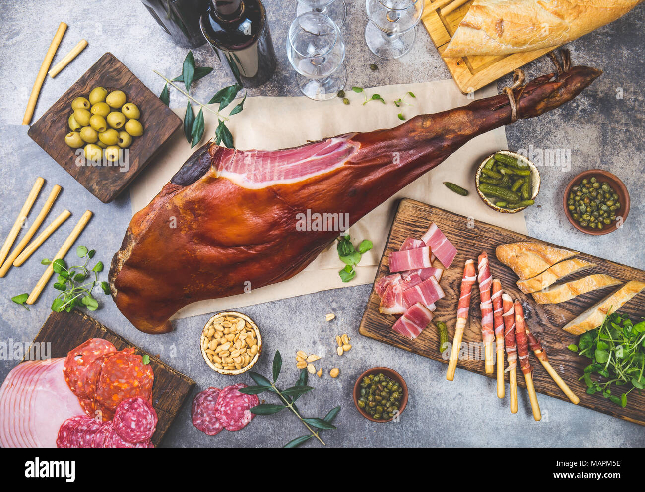 Appetizers table with spanish iberian whole ham jamon serrano, snacks ...