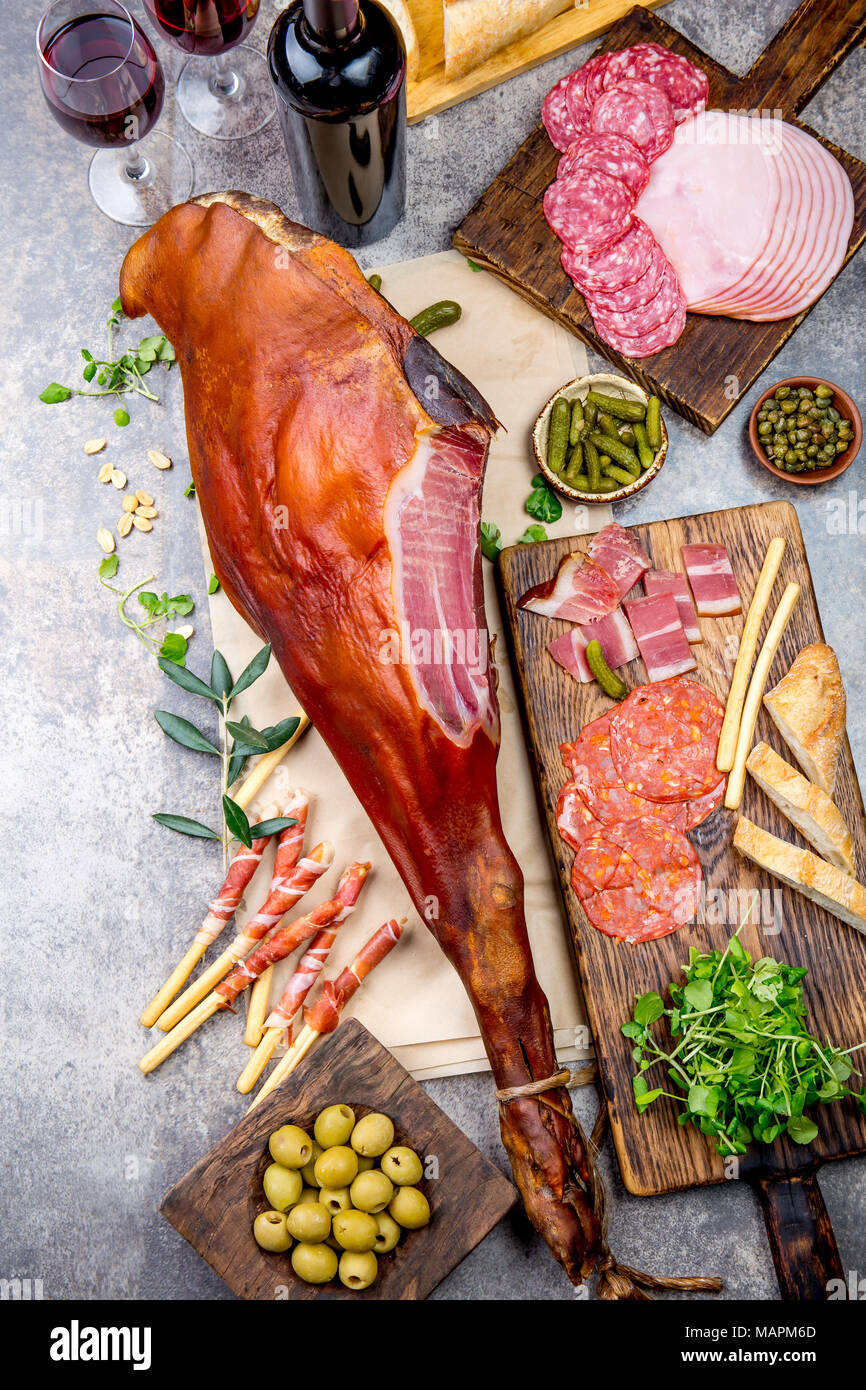 Appetizers table with spanish iberian whole ham jamon serrano, snacks ...