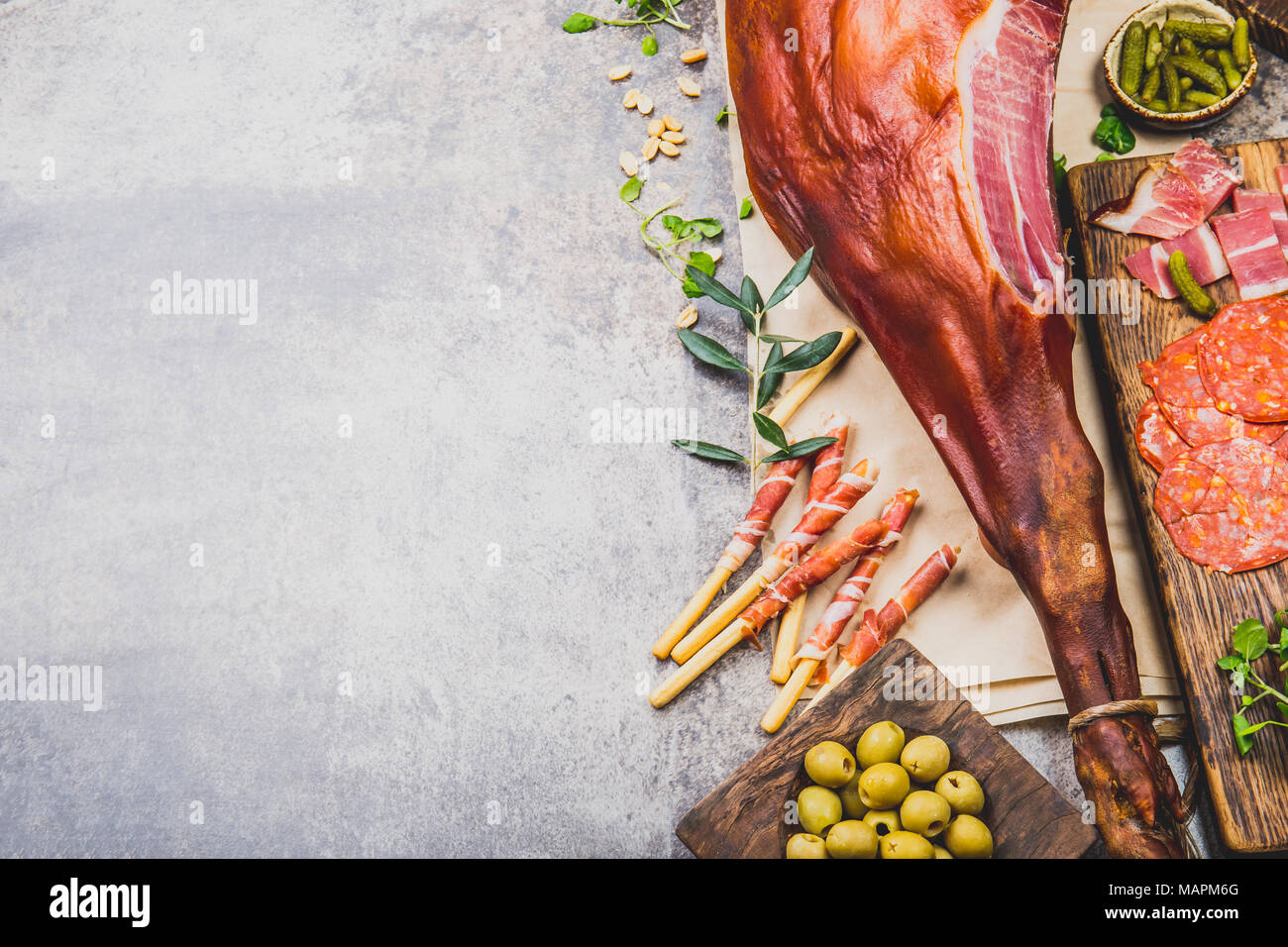 Appetizers table with spanish iberian whole ham jamon serrano, snacks ...