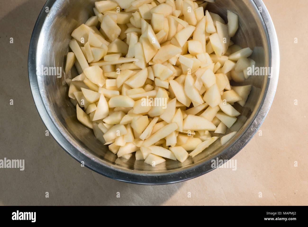 Chopped peeled pears in a metal bowl Stock Photo - Alamy