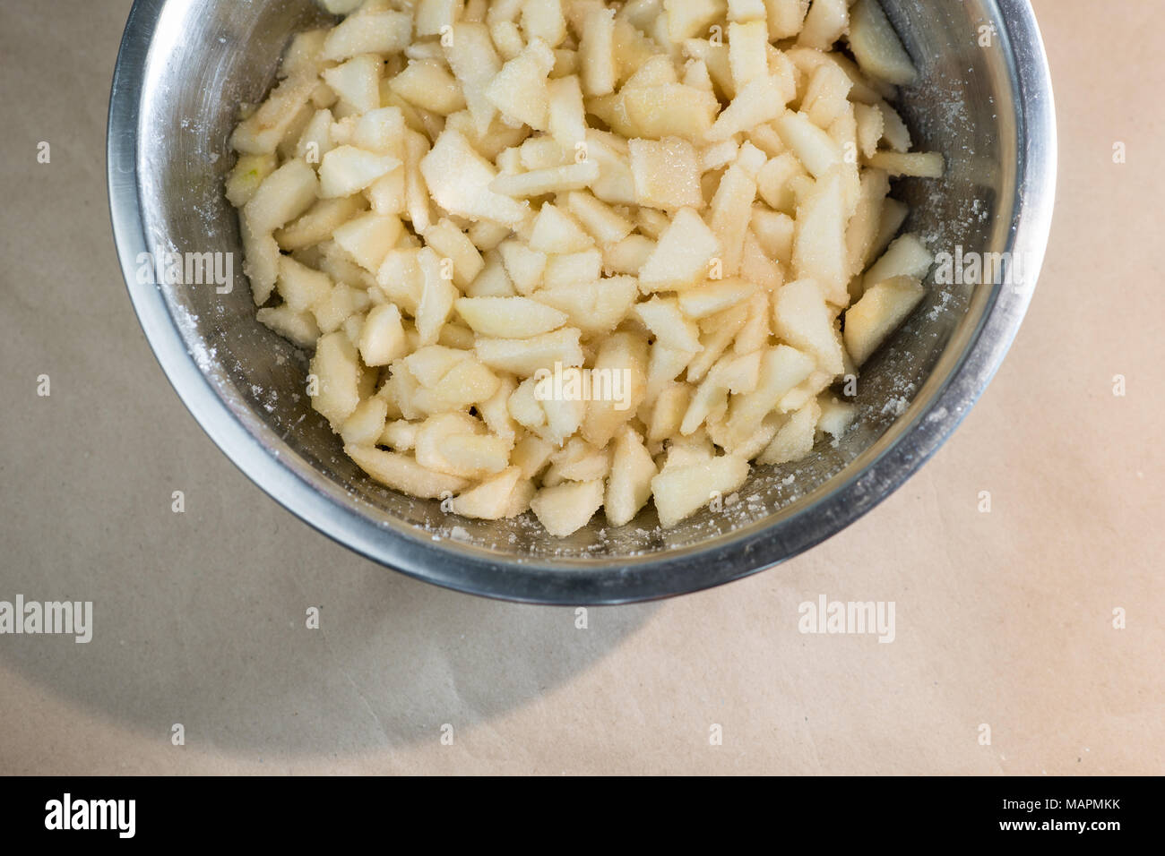 Chopped peeled pears mixed with sugar in a metal bowl Stock Photo - Alamy