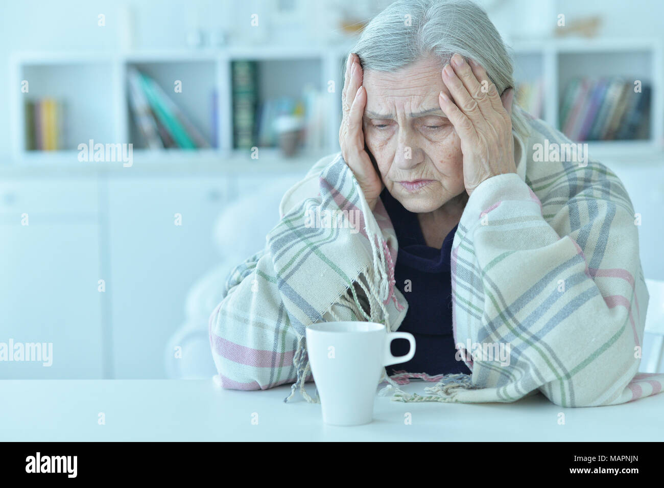 sad old woman with headache drinking tea Stock Photo - Alamy