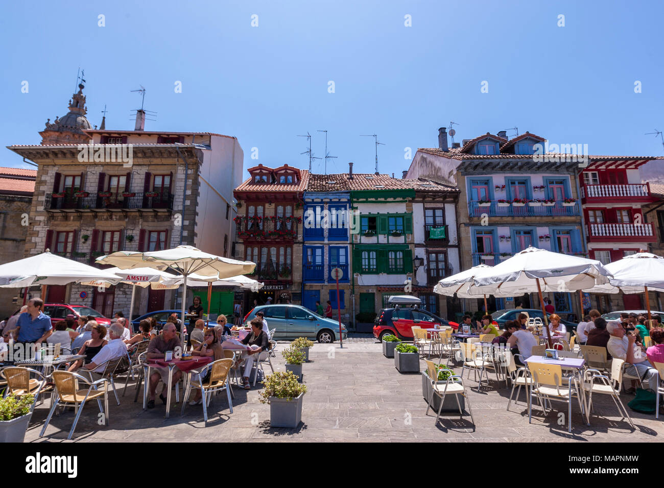 People in terraces outside Parador de Hondarribia, Castle of Charles V ...