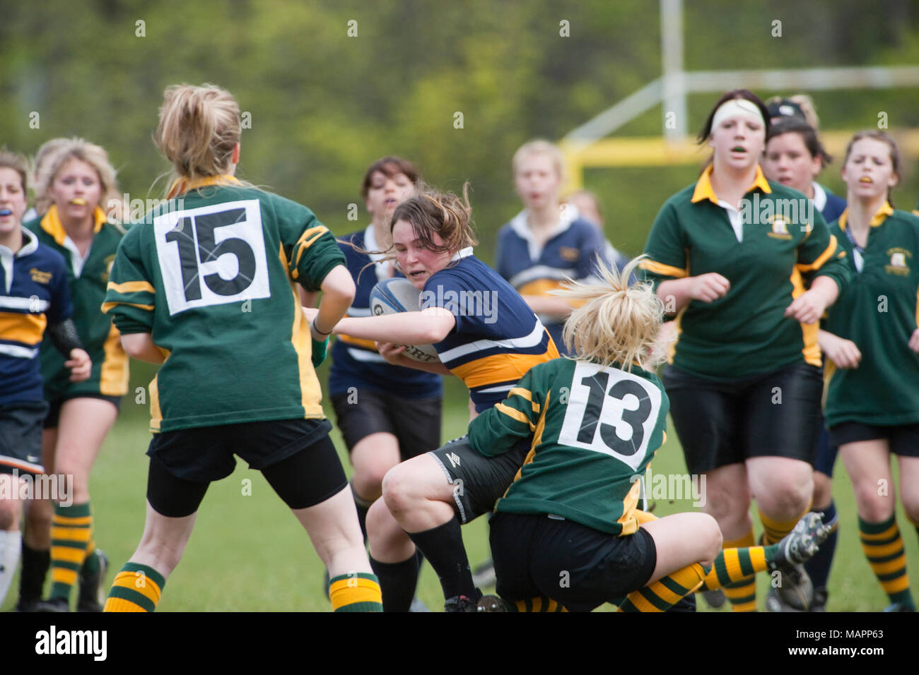 girl being tackled in rugby game Stock Photo - Alamy