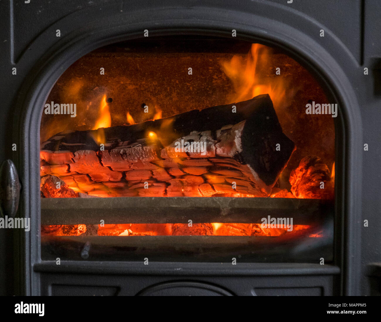 Logs burning in a log fire Stock Photo - Alamy