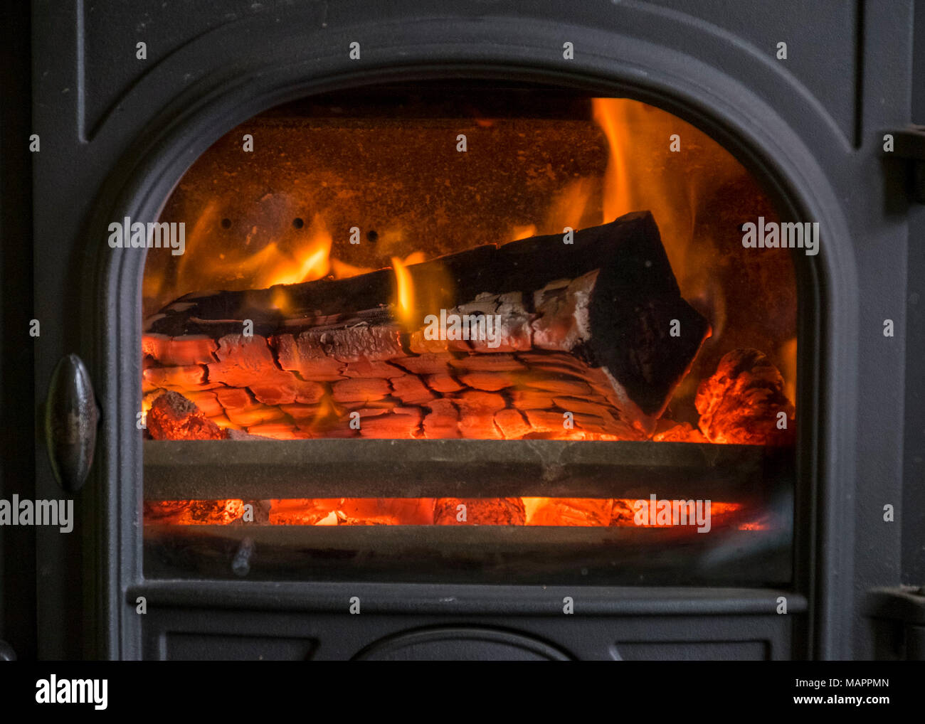 Logs burning in a log fire Stock Photo - Alamy