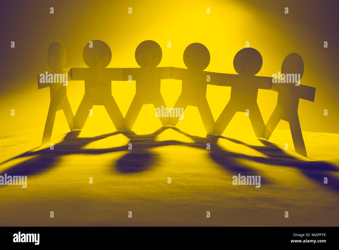 Team of paper chain people in a row holding hands Stock Photo - Alamy