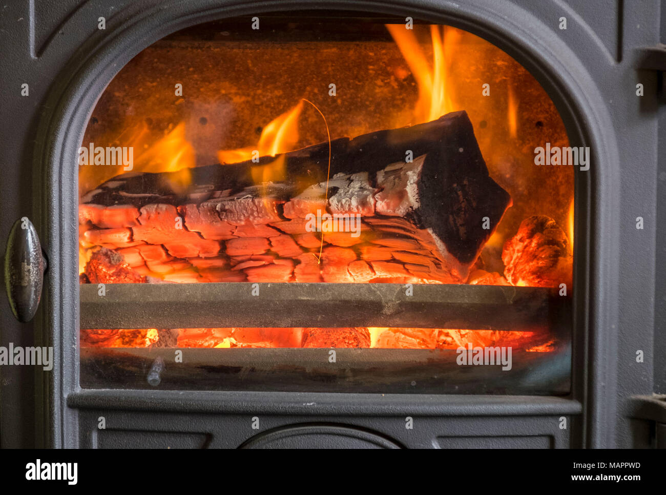Logs burning in a log fire Stock Photo - Alamy