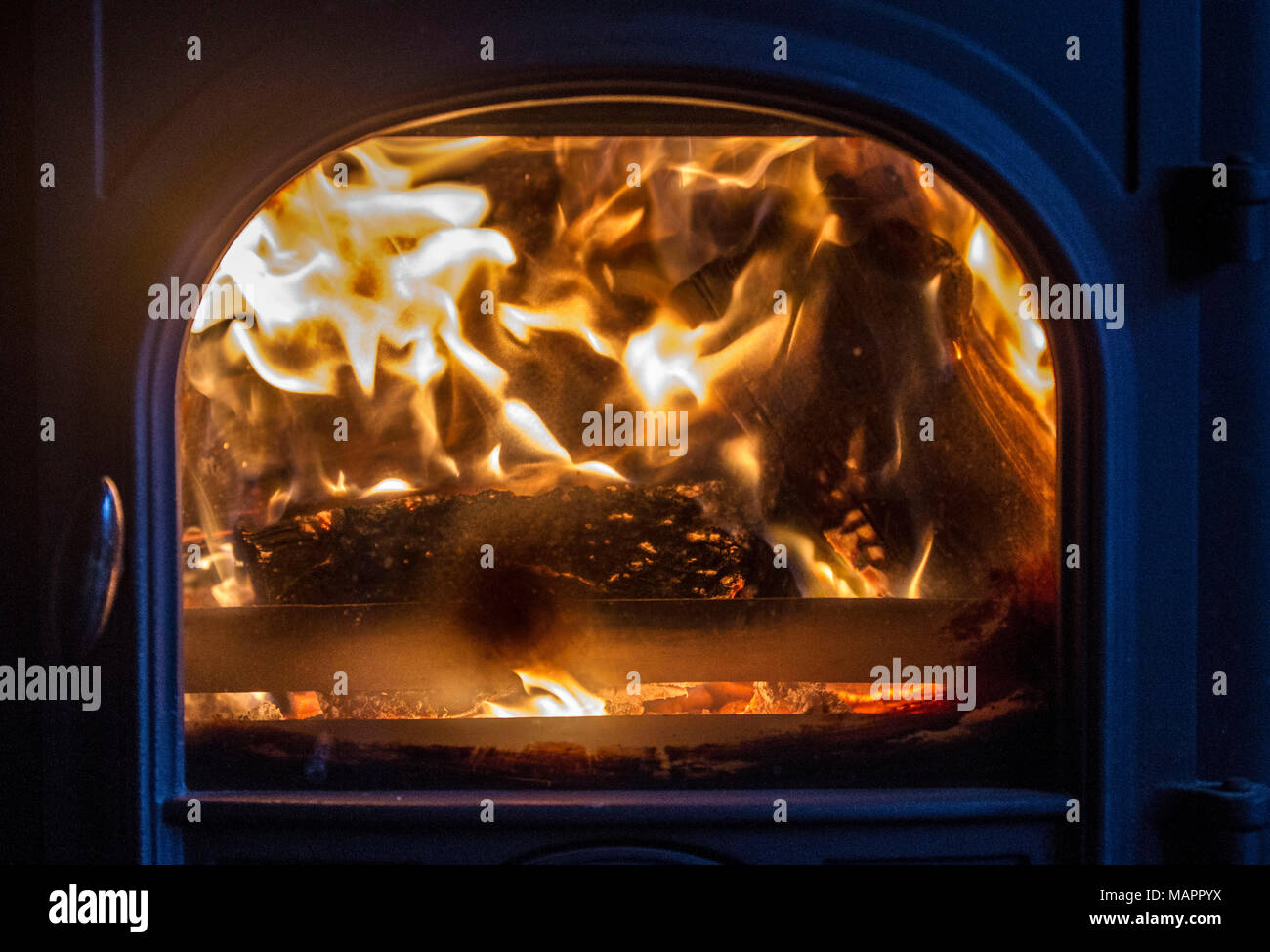 Logs burning in a log fire Stock Photo - Alamy
