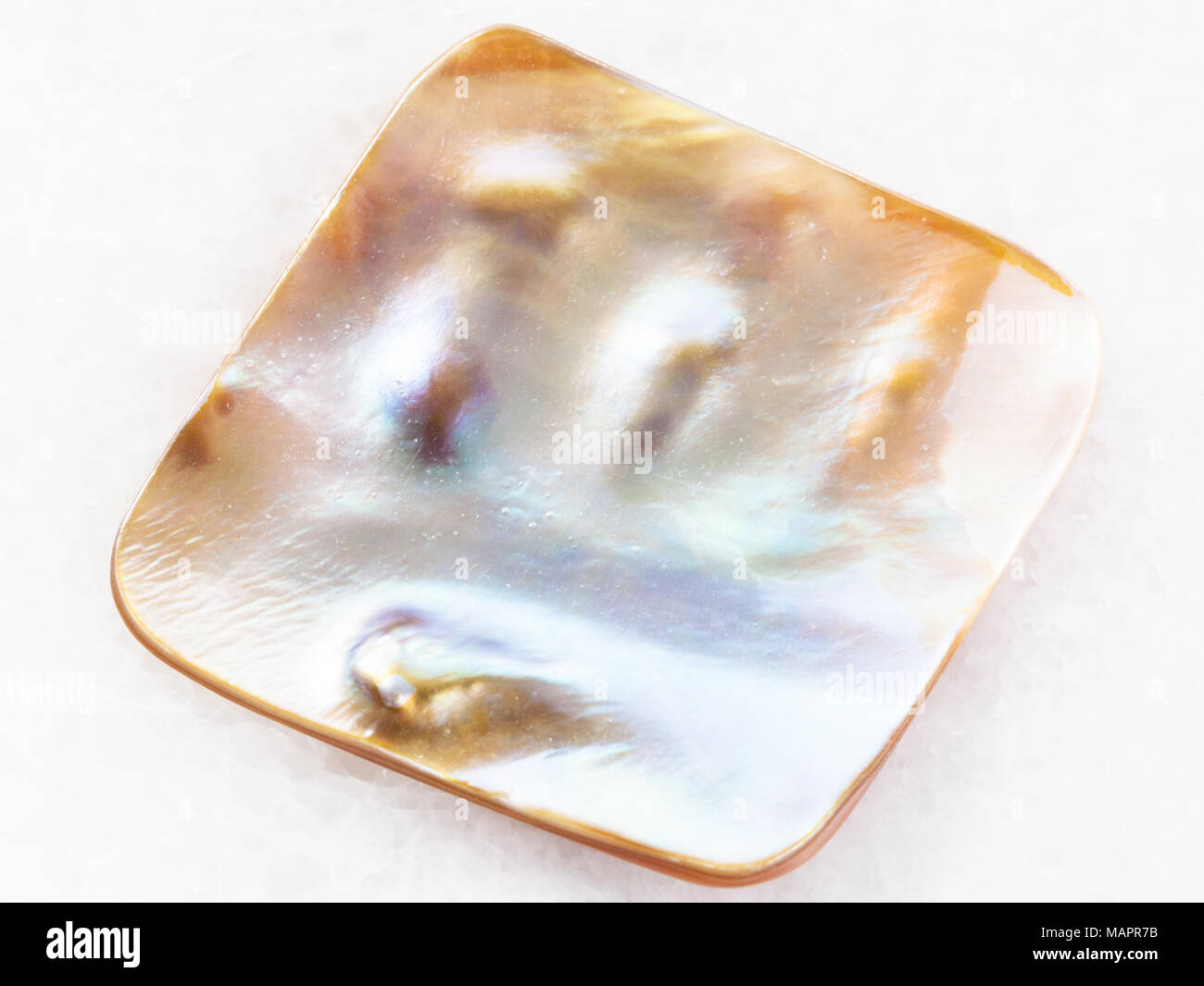macro shooting of natural mineral rock specimen - bead from nacre shell ...