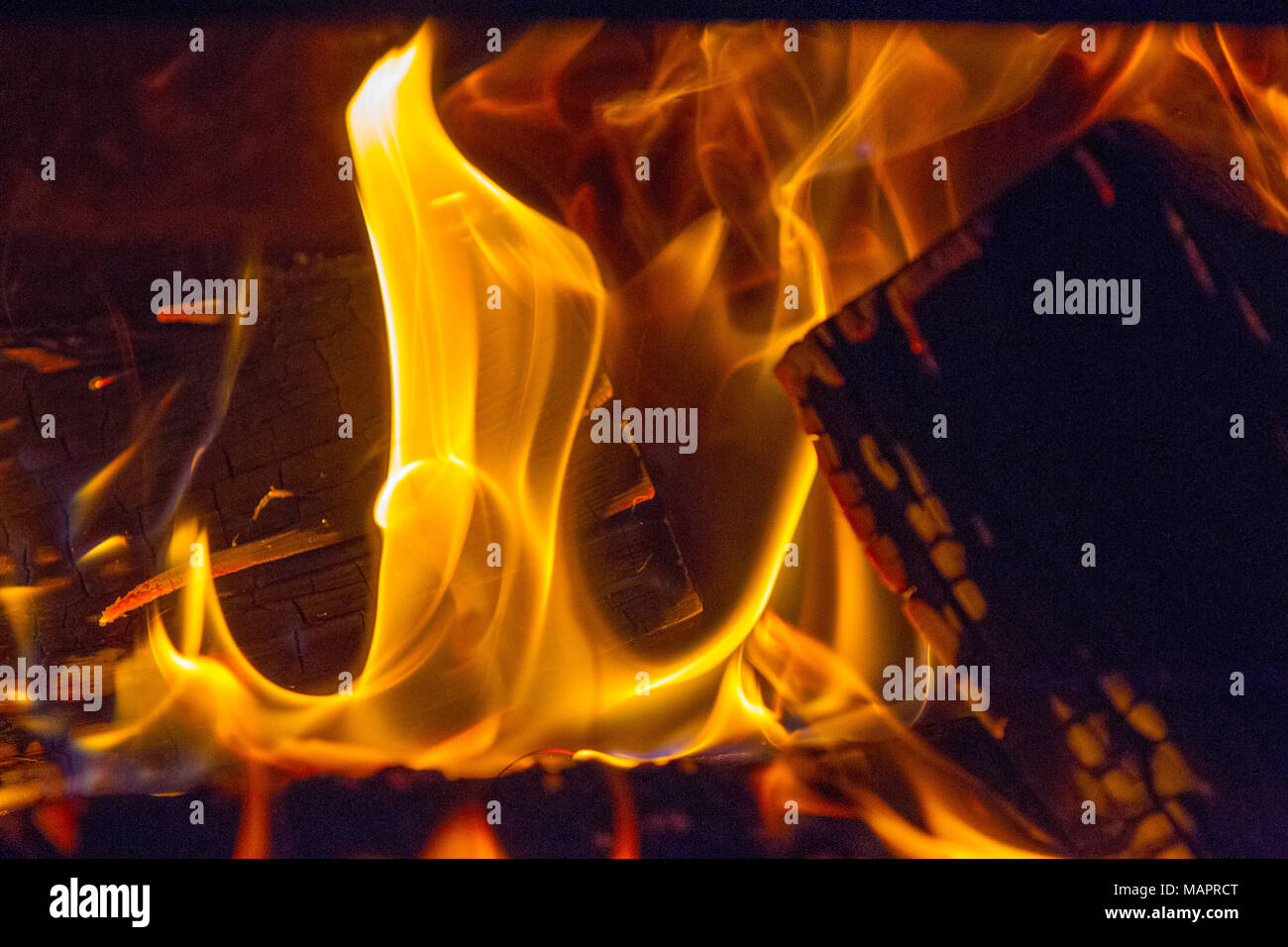 Logs burning in a log fire Stock Photo - Alamy