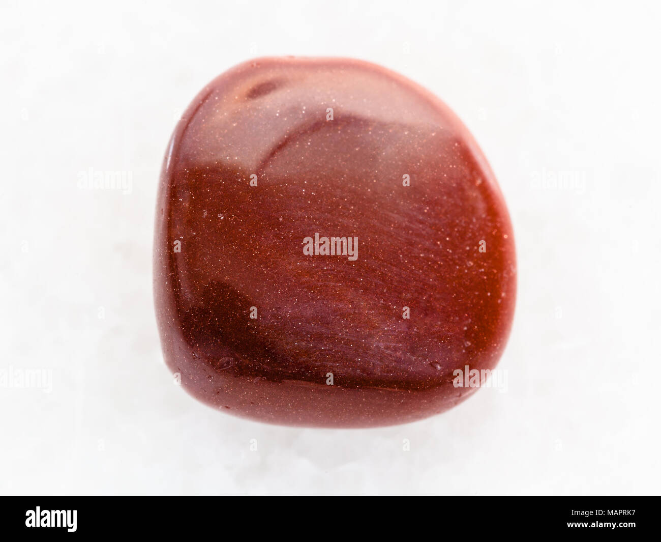 macro shooting of mineral rock specimen - tumbled red goldstone ...