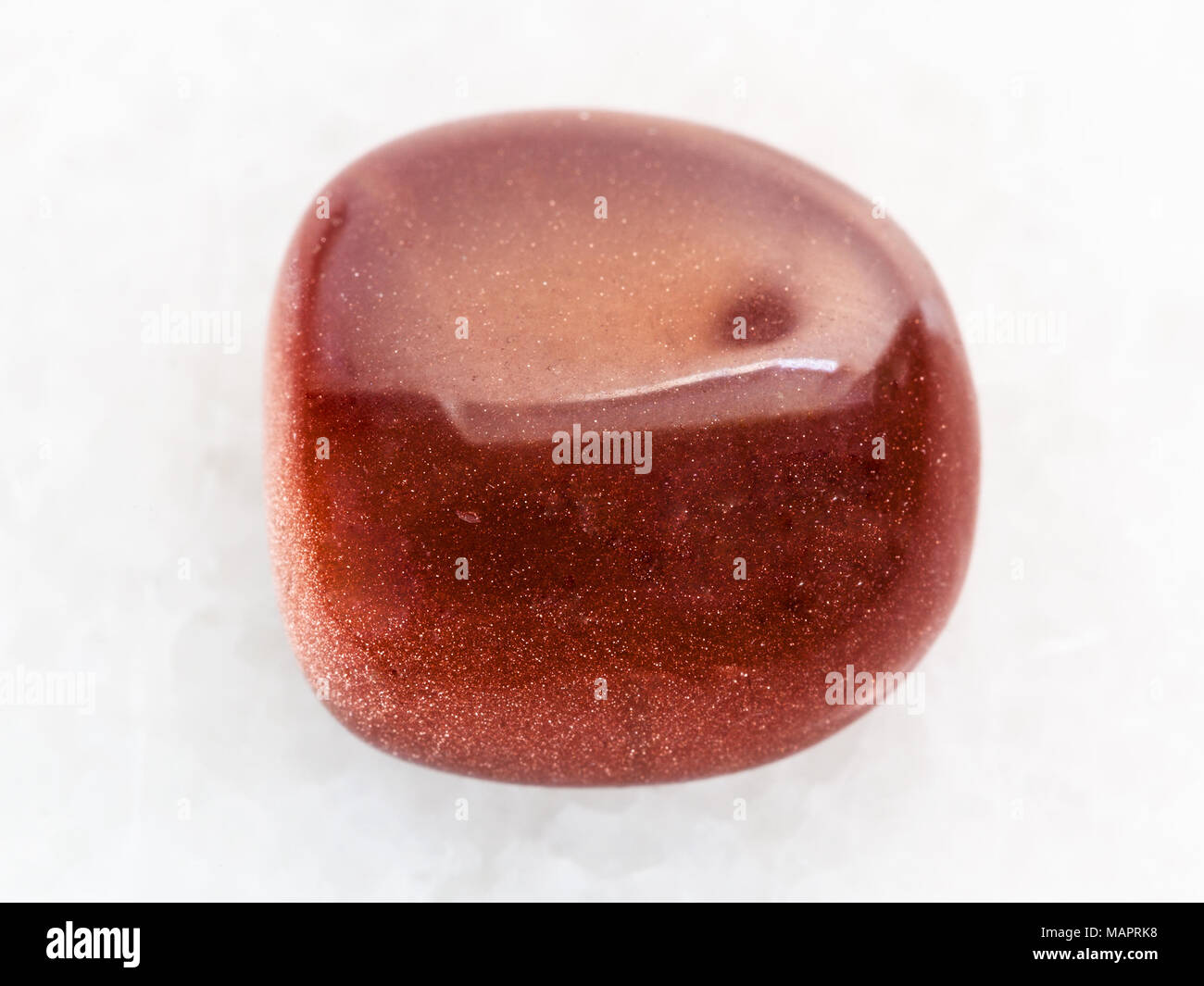 macro shooting of mineral rock specimen - polished red goldstone ...