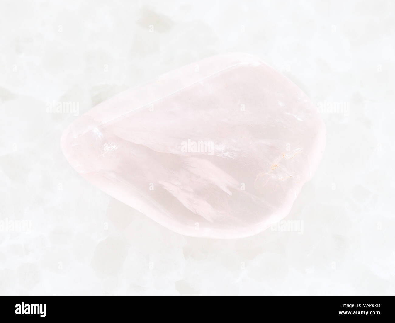 macro shooting of natural mineral rock specimen - tumbled pink quartz ...