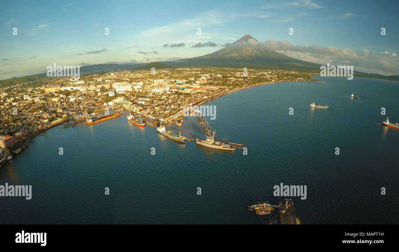 Aerial panorama of the city of Legaspi in the morning at dawn. Against ...