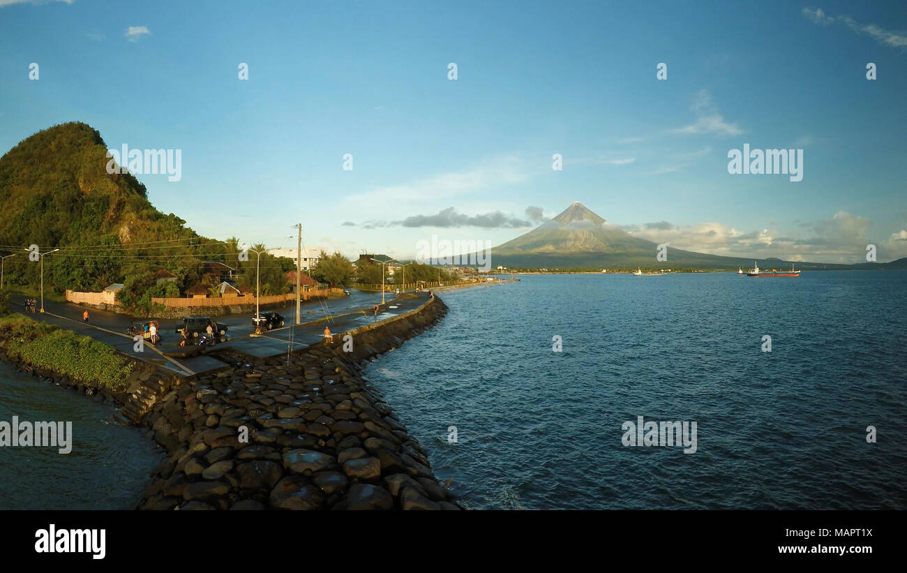 Aerial panorama of the city of Legaspi in the morning at dawn. Against ...