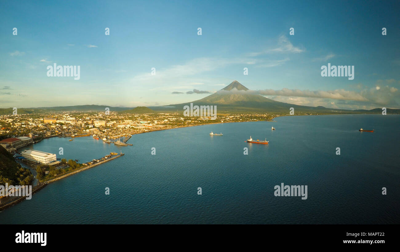 Aerial panorama of the city of Legaspi in the morning at dawn. Against ...