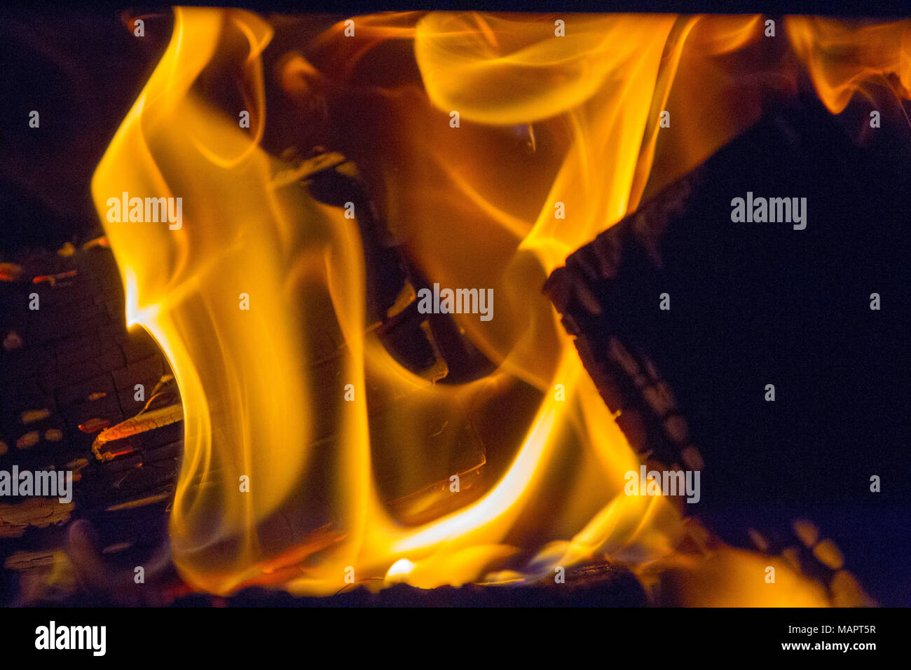 Logs burning in a log fire Stock Photo - Alamy