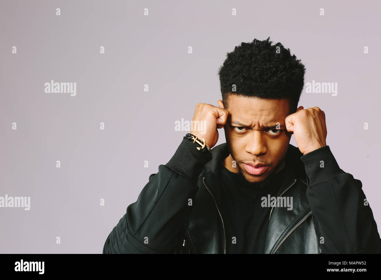 Portrait of an angry and depressed young man, isolated on studio ...