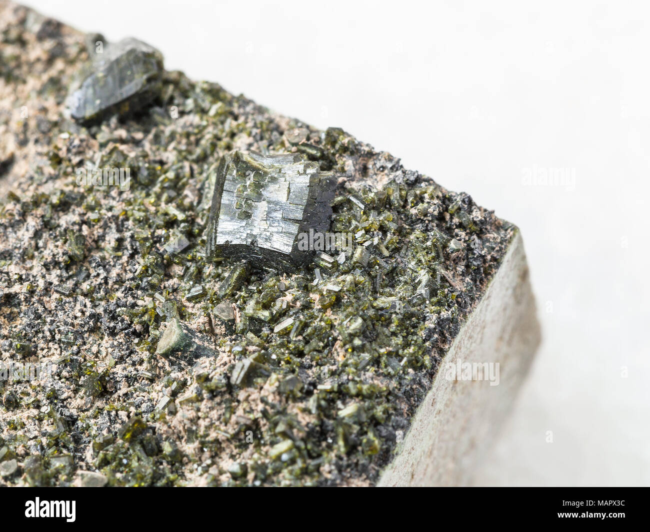 macro shooting of natural mineral stone specimen - crystals of Epidote ...