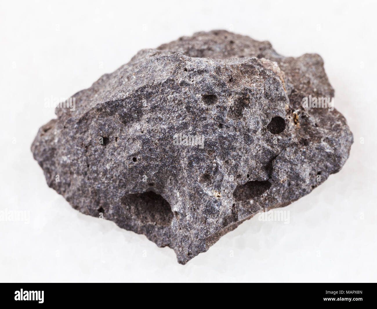 macro shooting of natural mineral rock specimen - pebble of gray basalt ...