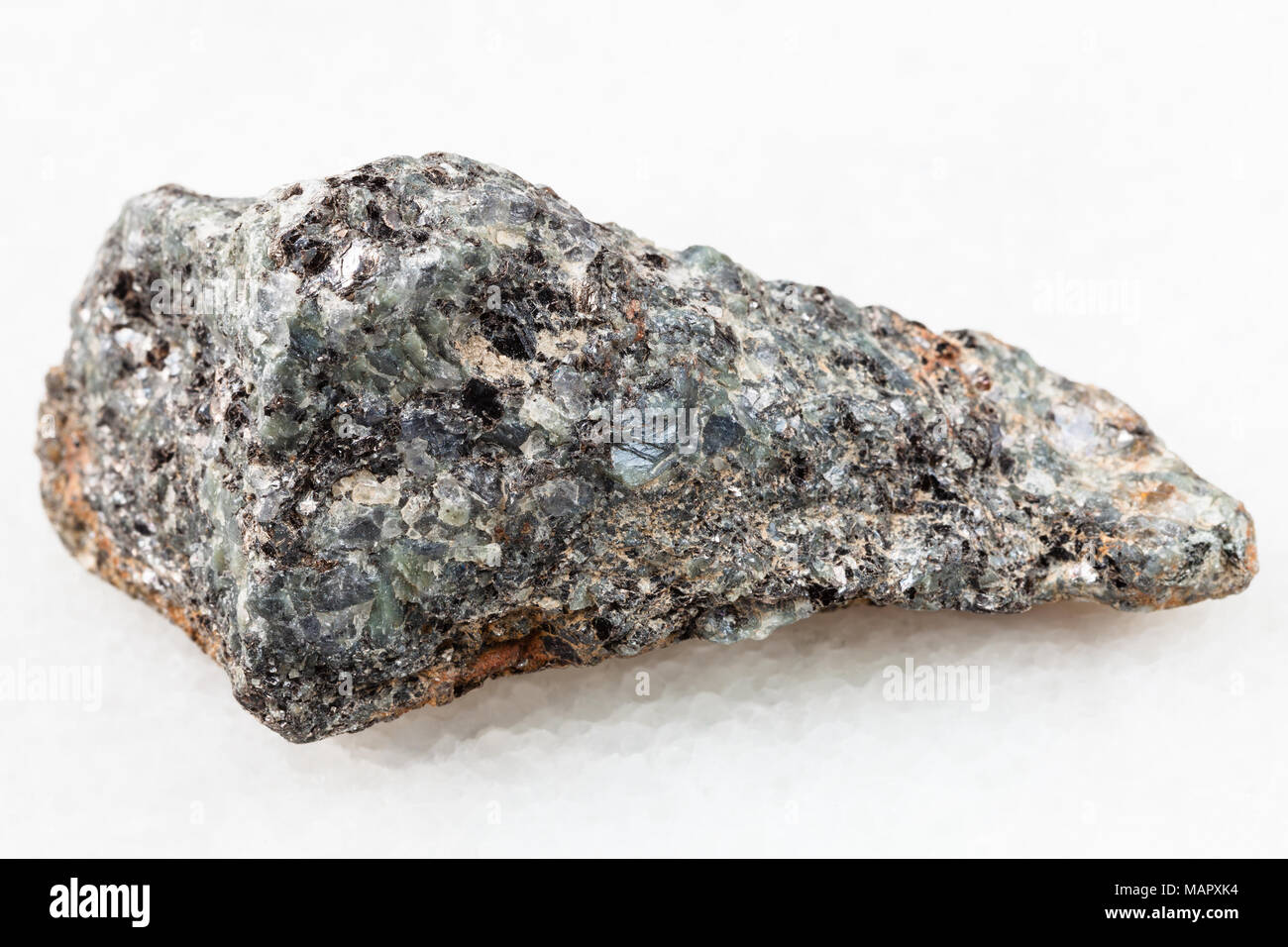 macro shooting of natural mineral rock specimen - rough biotite nepheline syenite stone on white ...