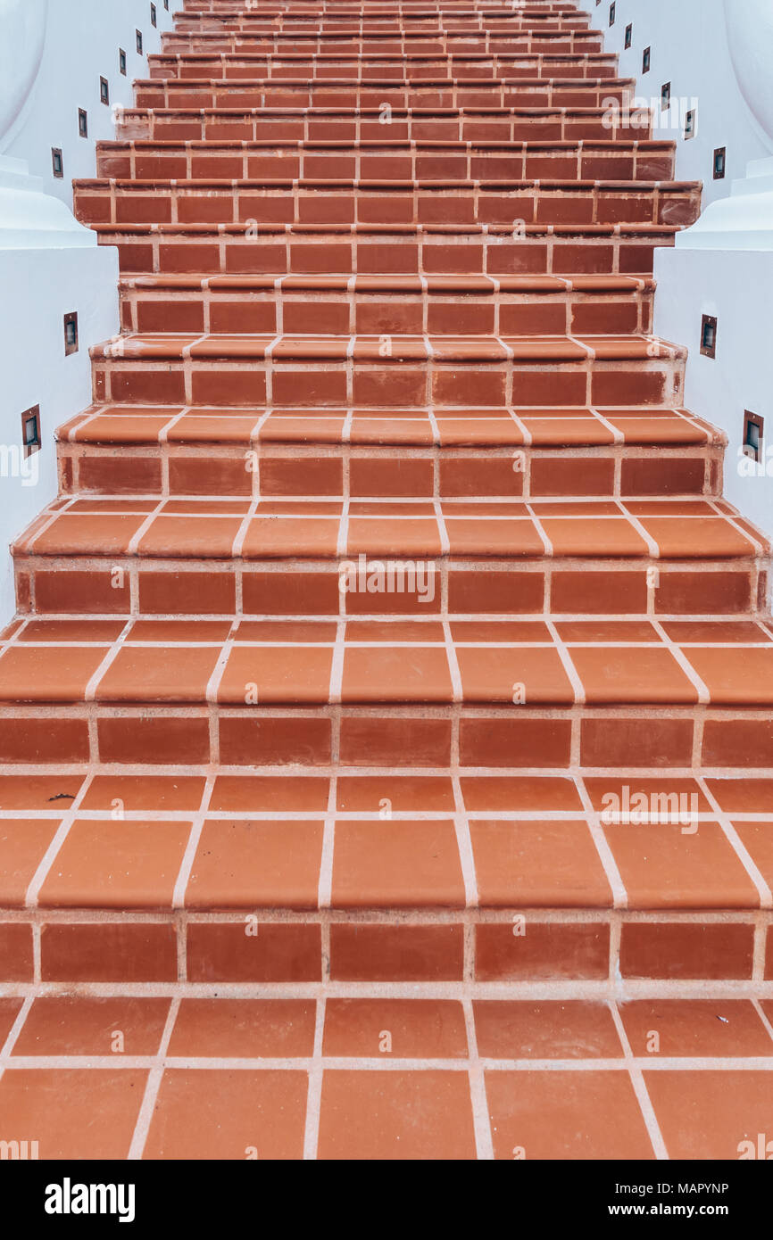 Tiled steps outside a temple with a white wall surround Stock Photo - Alamy