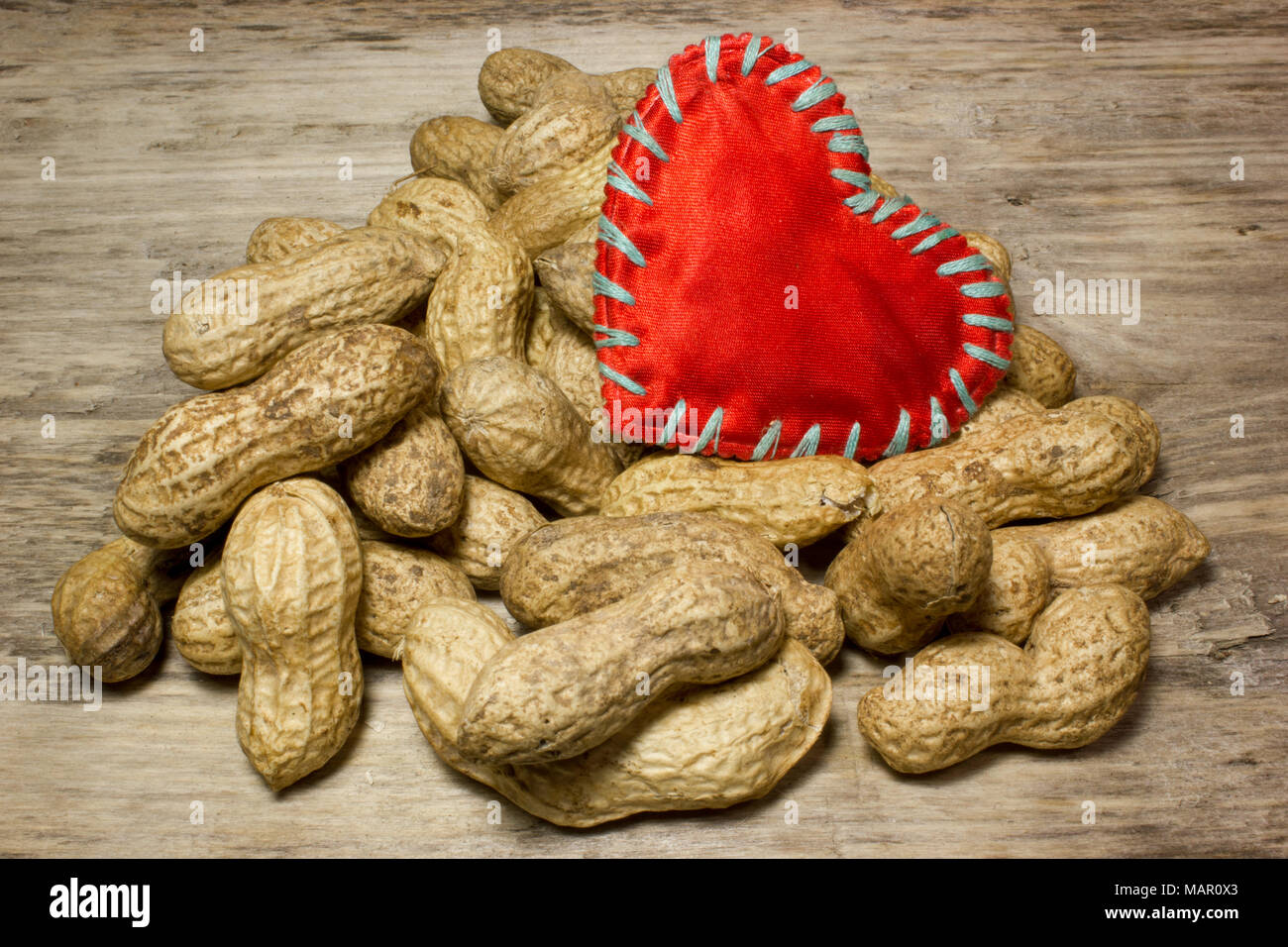 Peanuts in shell and red heart love on wooden background Stock Photo ...