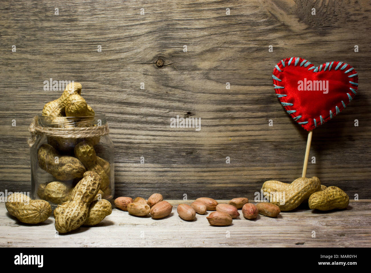 Peanuts in shell and red heart love on wooden background Stock Photo ...