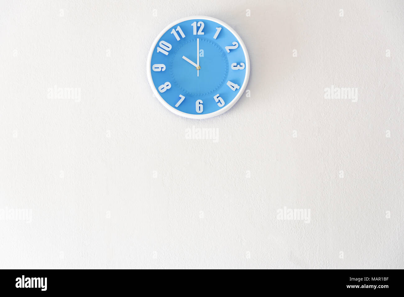 Morning, night or bed time with 10:00 clock on white concrete wall ...