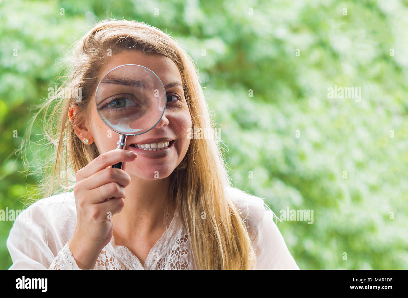 Great concept of research and investigation, young blond woman looking ...