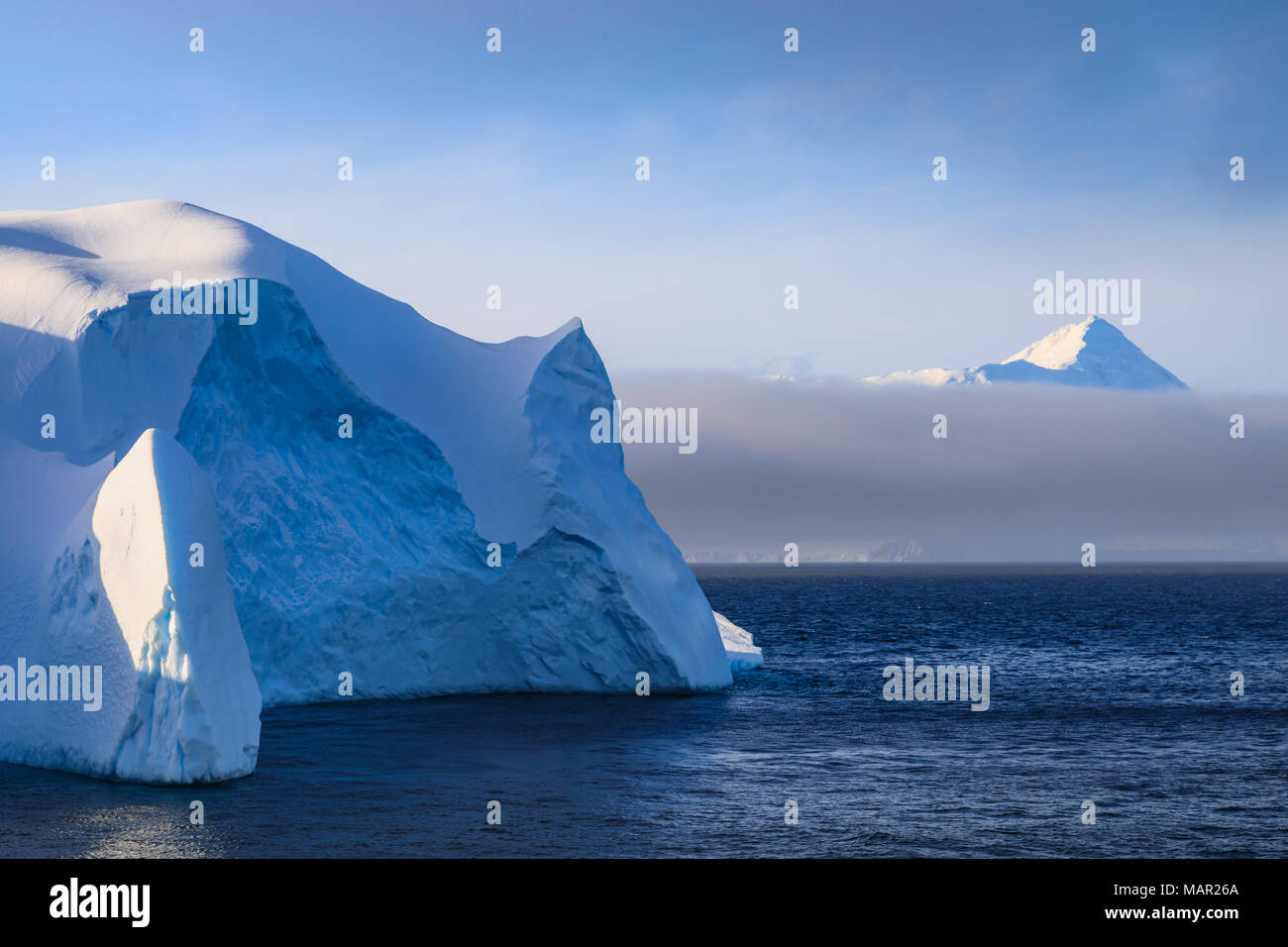 Huge iceberg, and mountain, clearing mist, Bransfield Strait, near ...