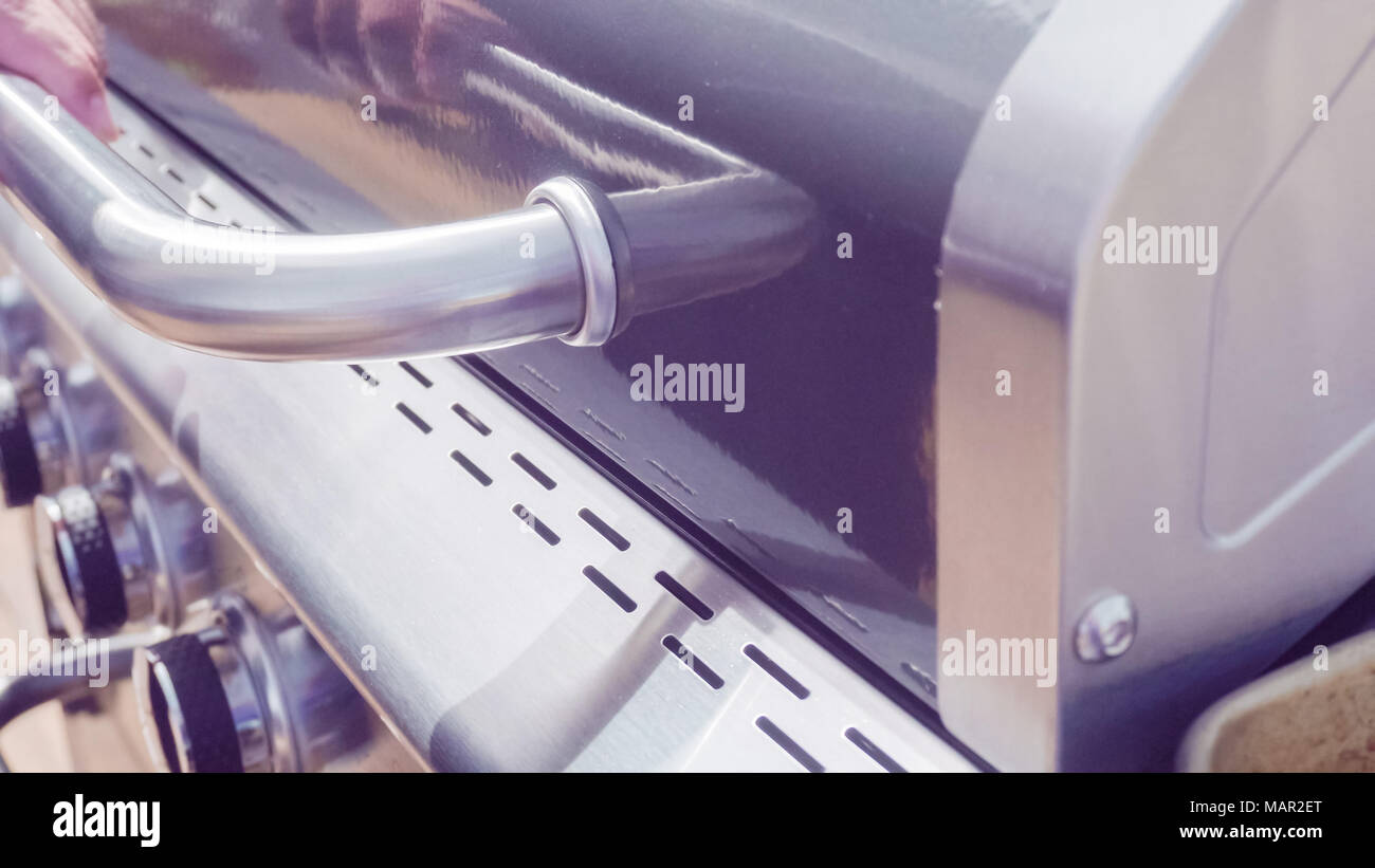 Grilling pork chops on gas grill in the Summer Stock Photo - Alamy